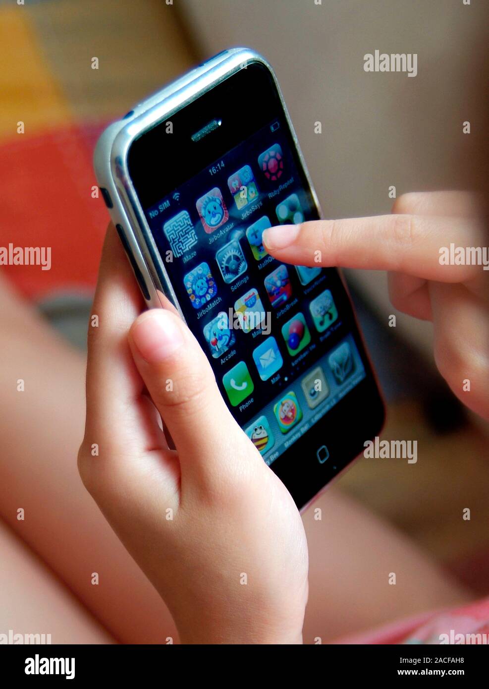 Girl touching the screen of an iphone Stock Photo - Alamy