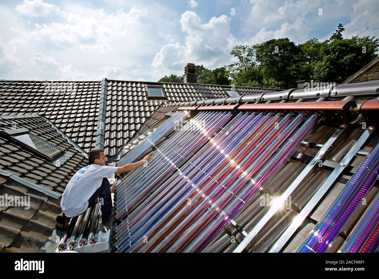 Vacuum tube solar panels assembly. Worker from a specialised ...