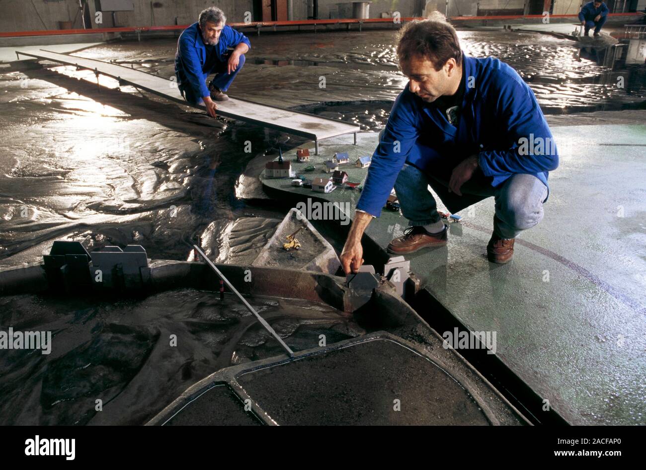 Coastal sediment deposition modelling. Researchers working on a water ...