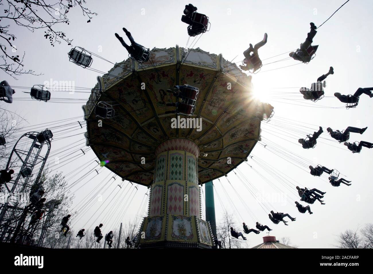 Theme park. Visitors on a ride at the Bobbejaanland theme park in ...