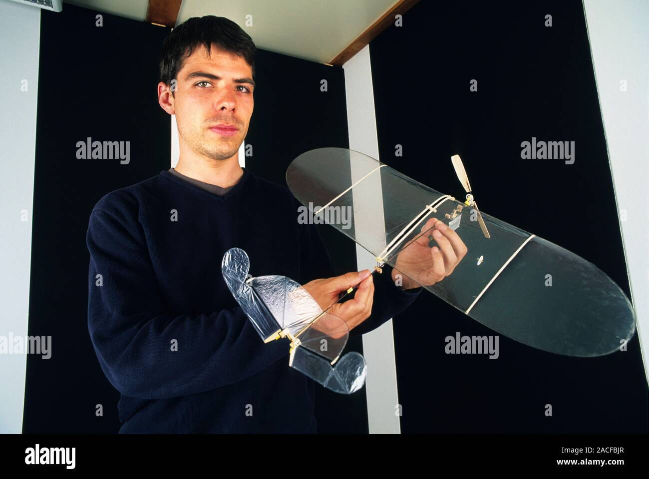 Robotics research. Researcher holding a winged autonomous robotic ...