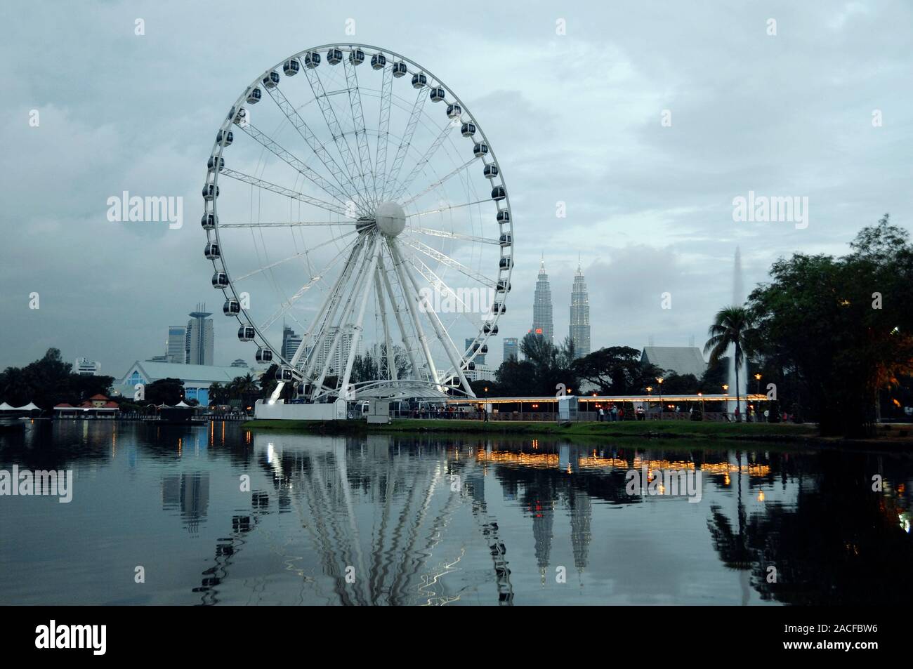 Kuala Lumpur landmarks. View of the Eye on Malaysia giant Ferris wheel by the side of Lake ...