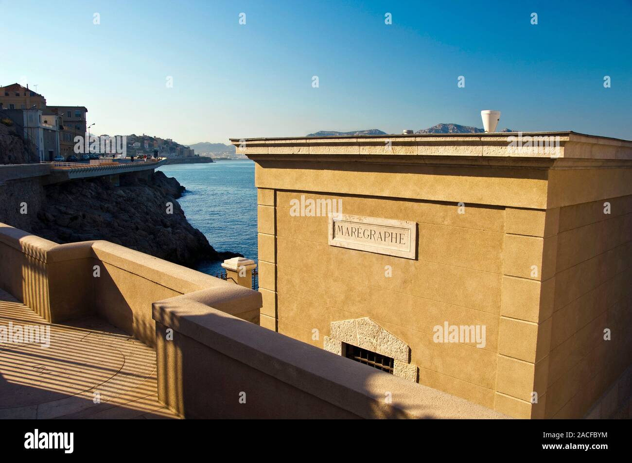 Tide gauge. Stone box on a sea wall housing a marigraph, a device for ...