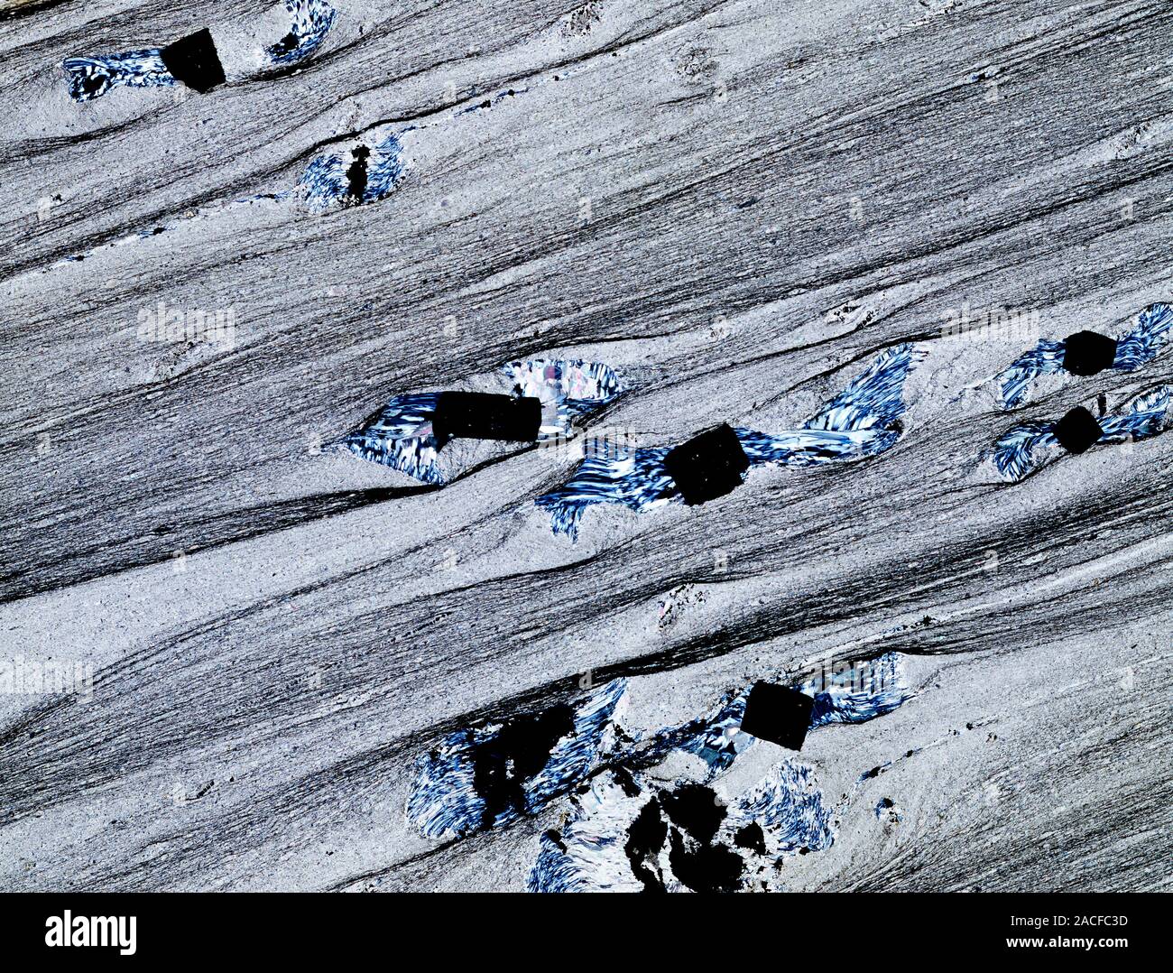 Rock strain fringes. Polarised light micrograph of strain fringes in a ...