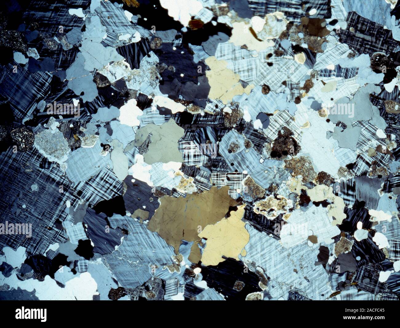 Granite rock. Polarised light micrograph of granite, a common and ...