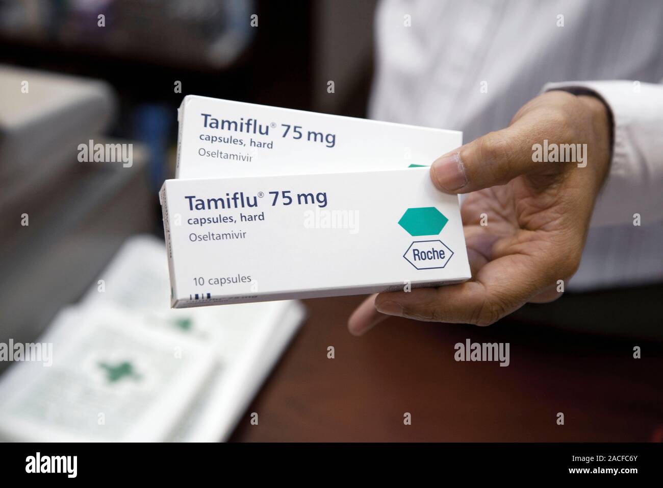 Tamiflu influenza drug. Pharmacist holding packets of tamiflu ...