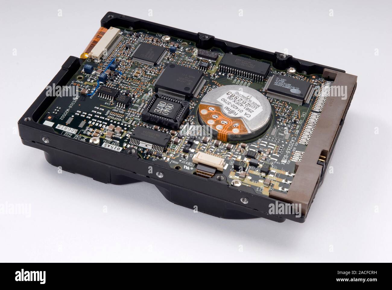 Computer hard disc. Underside of a computer's hard drive, showing the ...