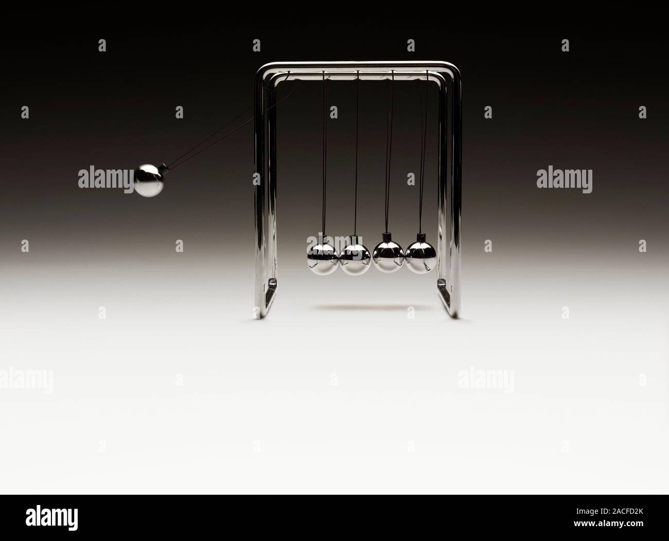 Newton's cradle in motion Stock Photo - Alamy