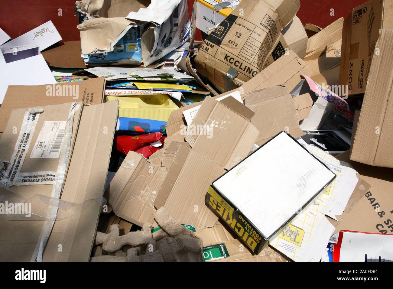 Cardboard boxes in a skip waiting for collection and disposal Stock ...