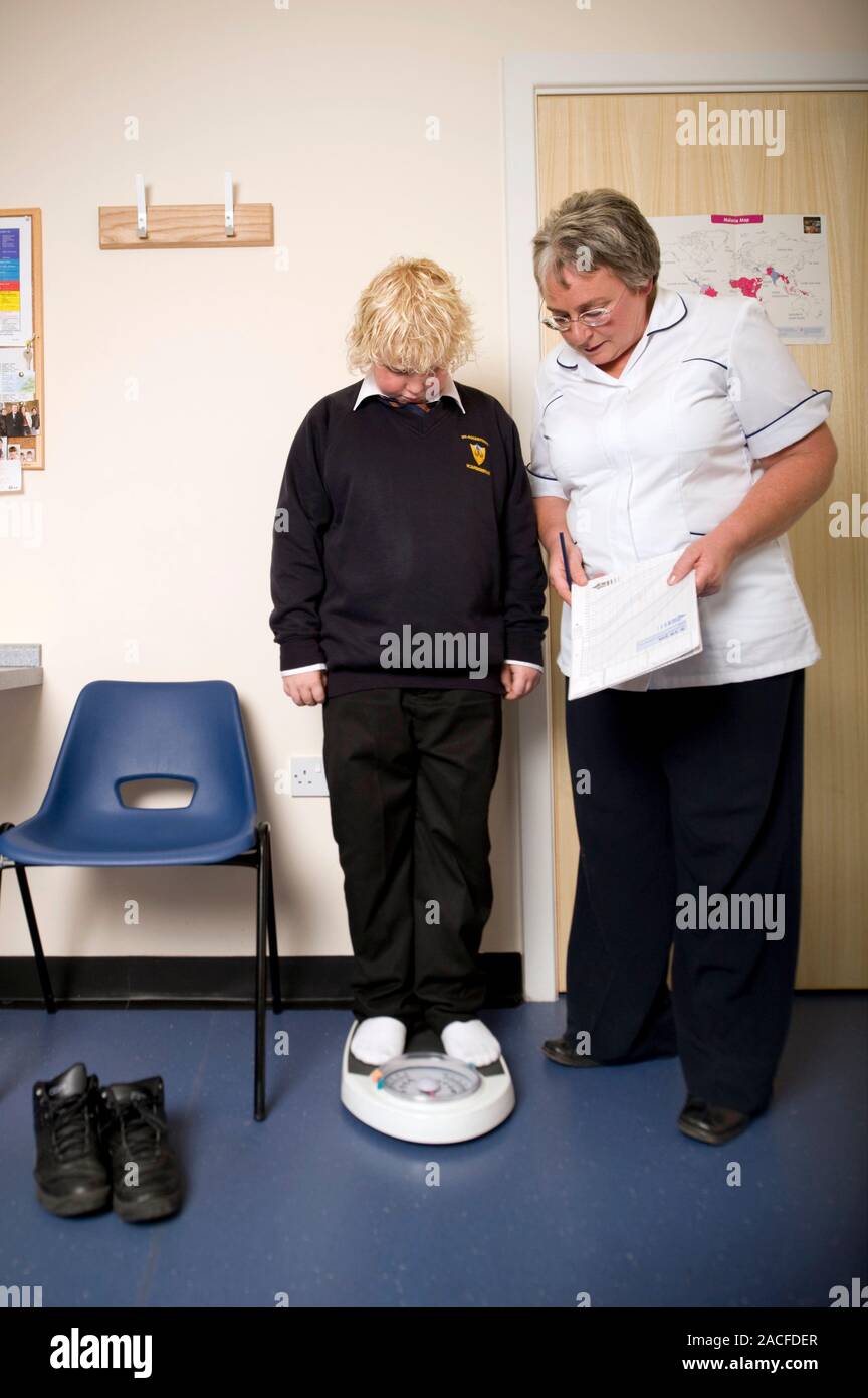 Boy measuring weight on weight scale Stock Photo - Alamy