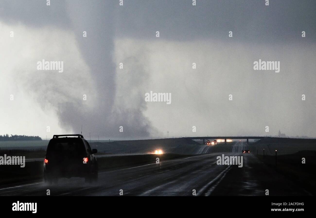 Tornado approaching road. A tornado is a violent rotating column of air ...