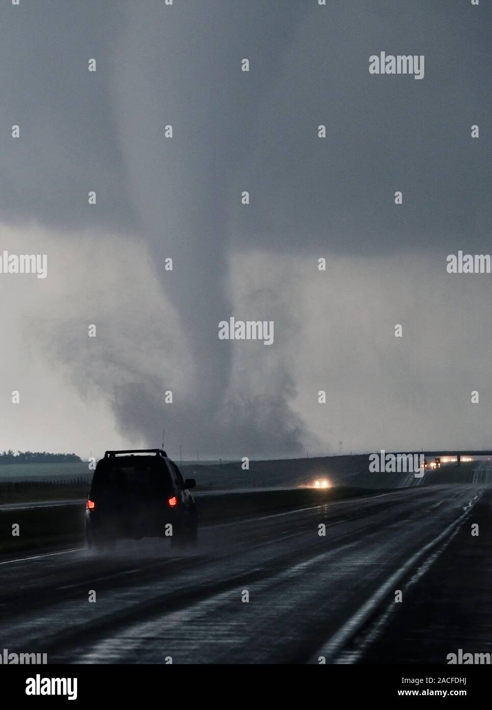 Tornado approaching road. A tornado is a violent rotating column of air ...