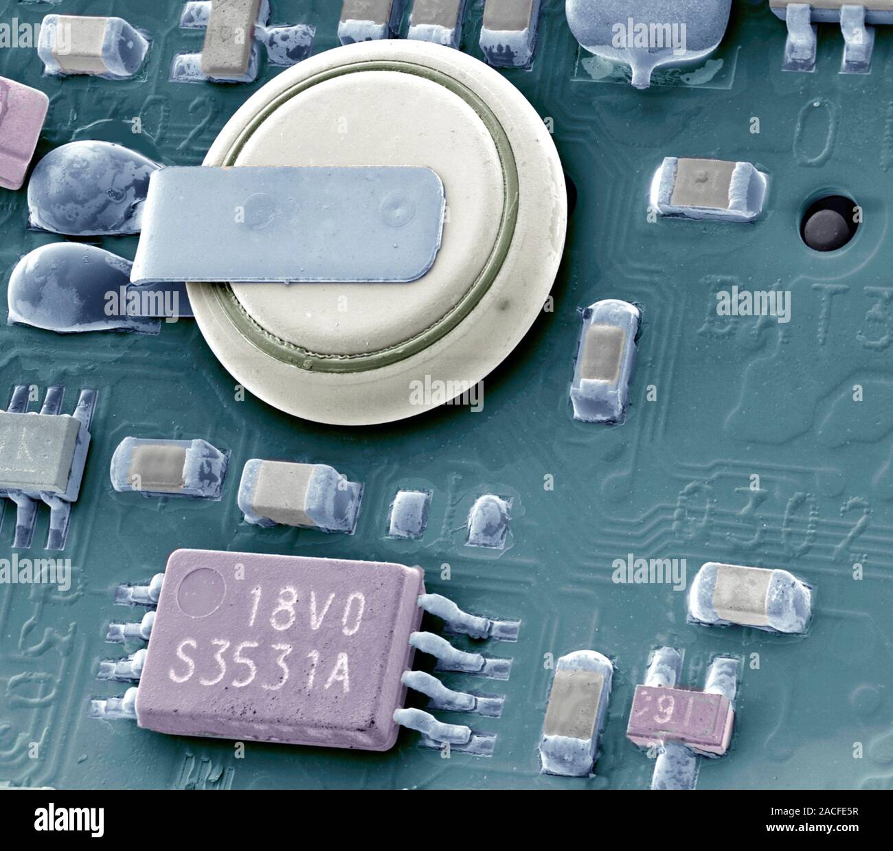 Circuit board battery. Coloured scanning electron micrograph (SEM) of a ...