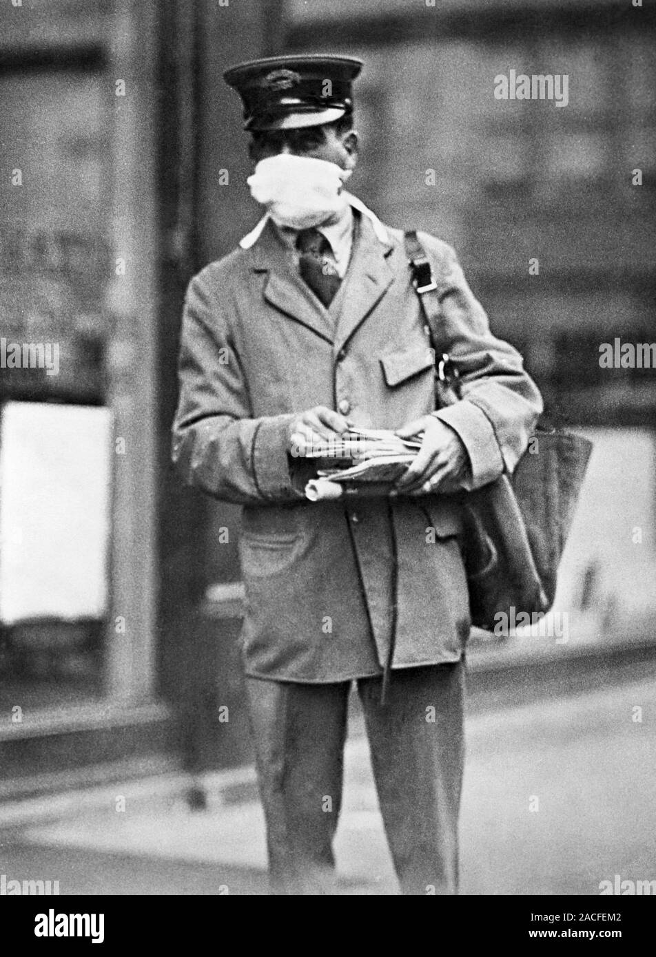 Letter carrier wearing a face mask for protection against the 1918 ...