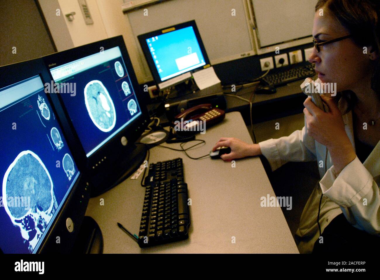 CT scanning. Doctor examining the results of a computed tomography (CT ...