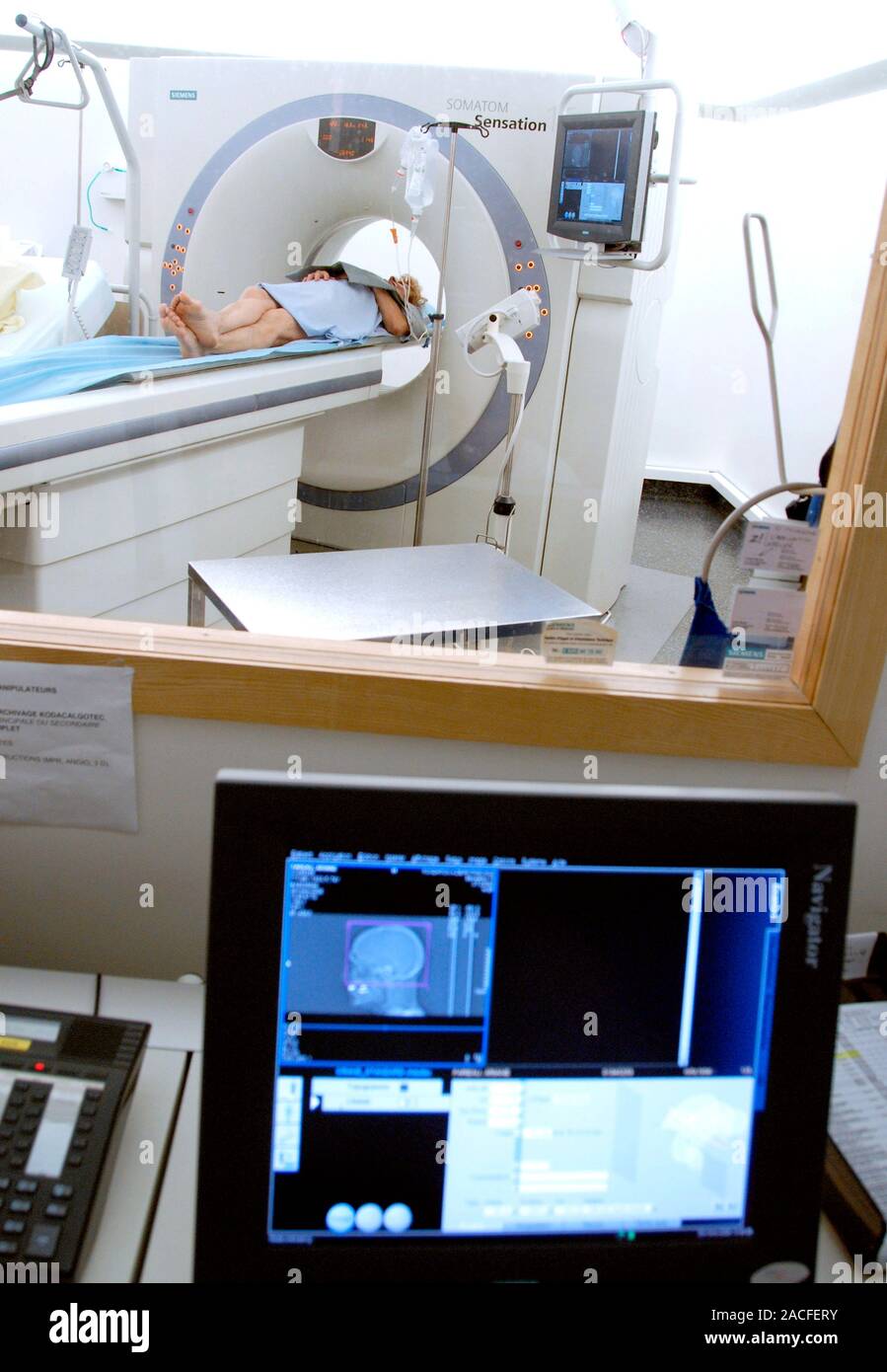 CT scanning. Patient undergoing a computed tomography (CT) scan. CT ...