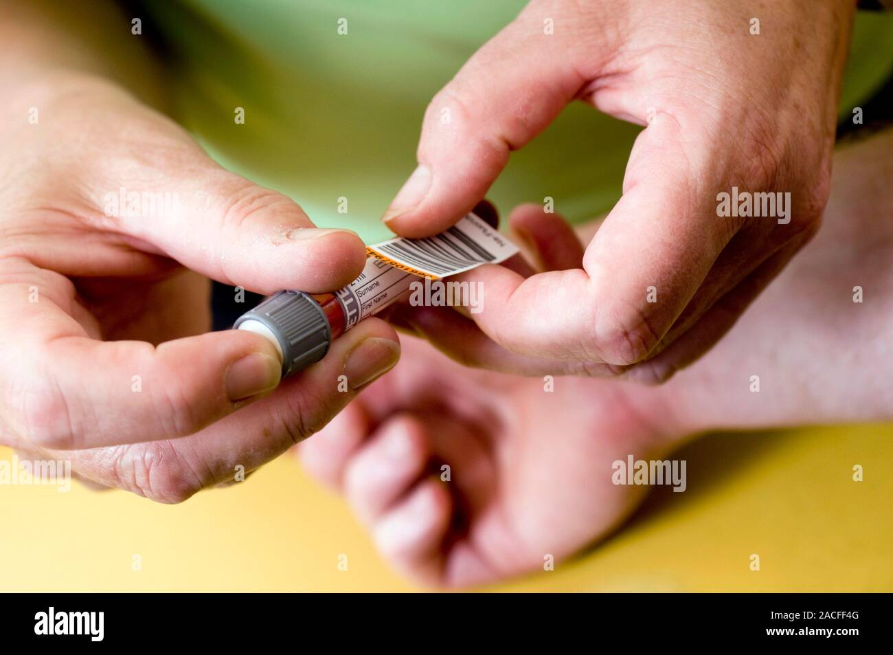 Taking a blood sample. Medical professional sticking an identity ...