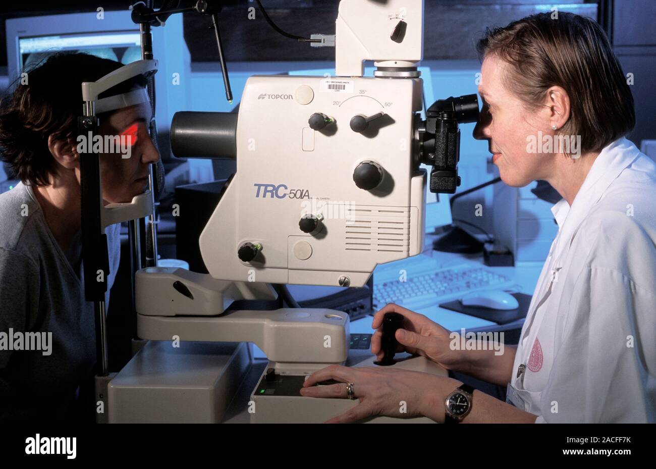 Eye examination. Doctor using a retinal camera during an angiography ...