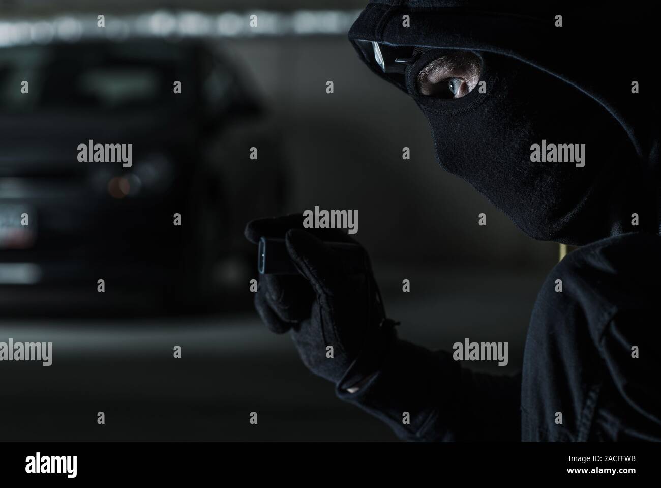 Caucasian Men Wearing Mask Preparing to Steal a Car Inside Underground ...