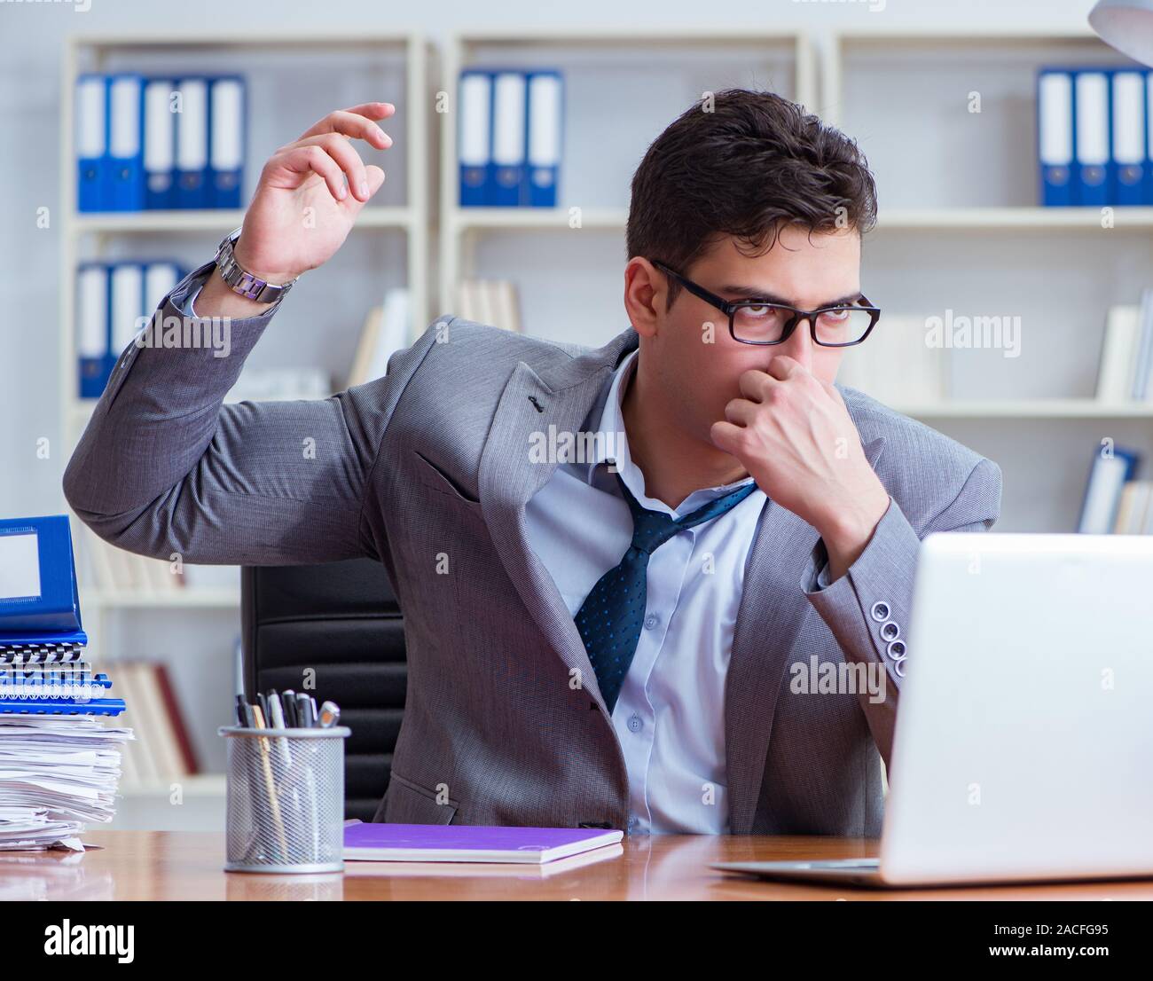 Businessman sweating excessively smelling bad in office at workplace ...