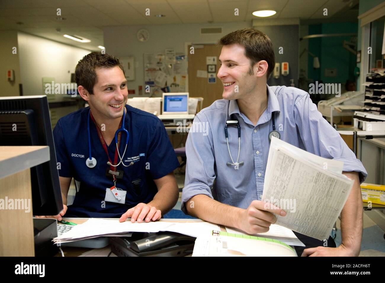 Hospital doctors entering patient notes into a computer database ...