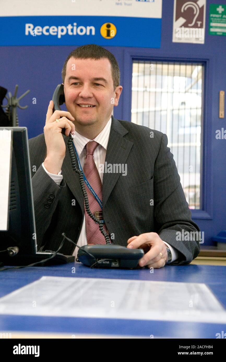 Hospital receptionist on a telephone. Photographed at the West ...