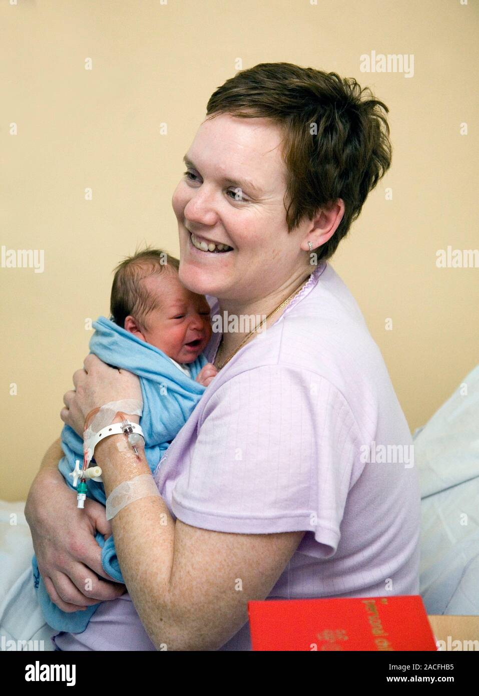 Mother and newborn baby on a maternity ward. Photographed at the West ...