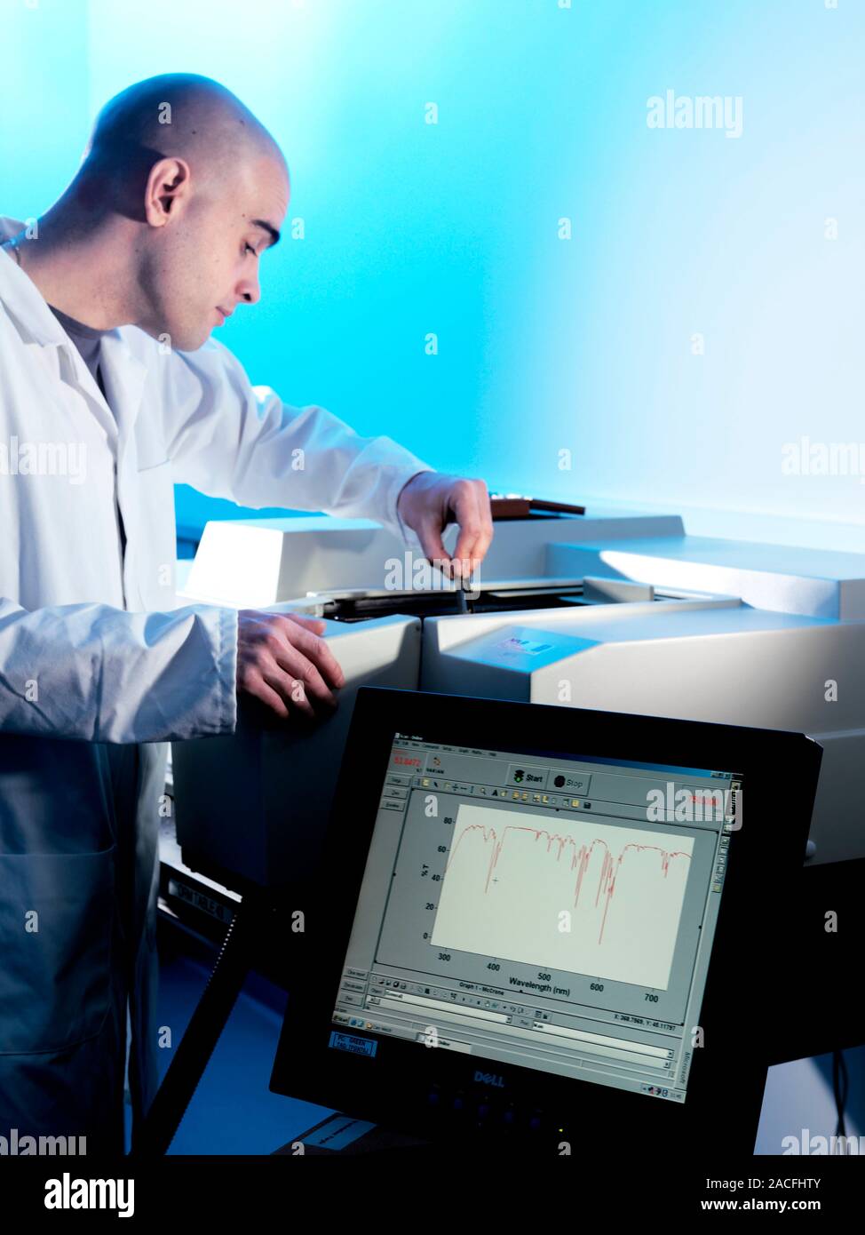 Spectrophotometry research. Technician using a spectrophotometer to ...