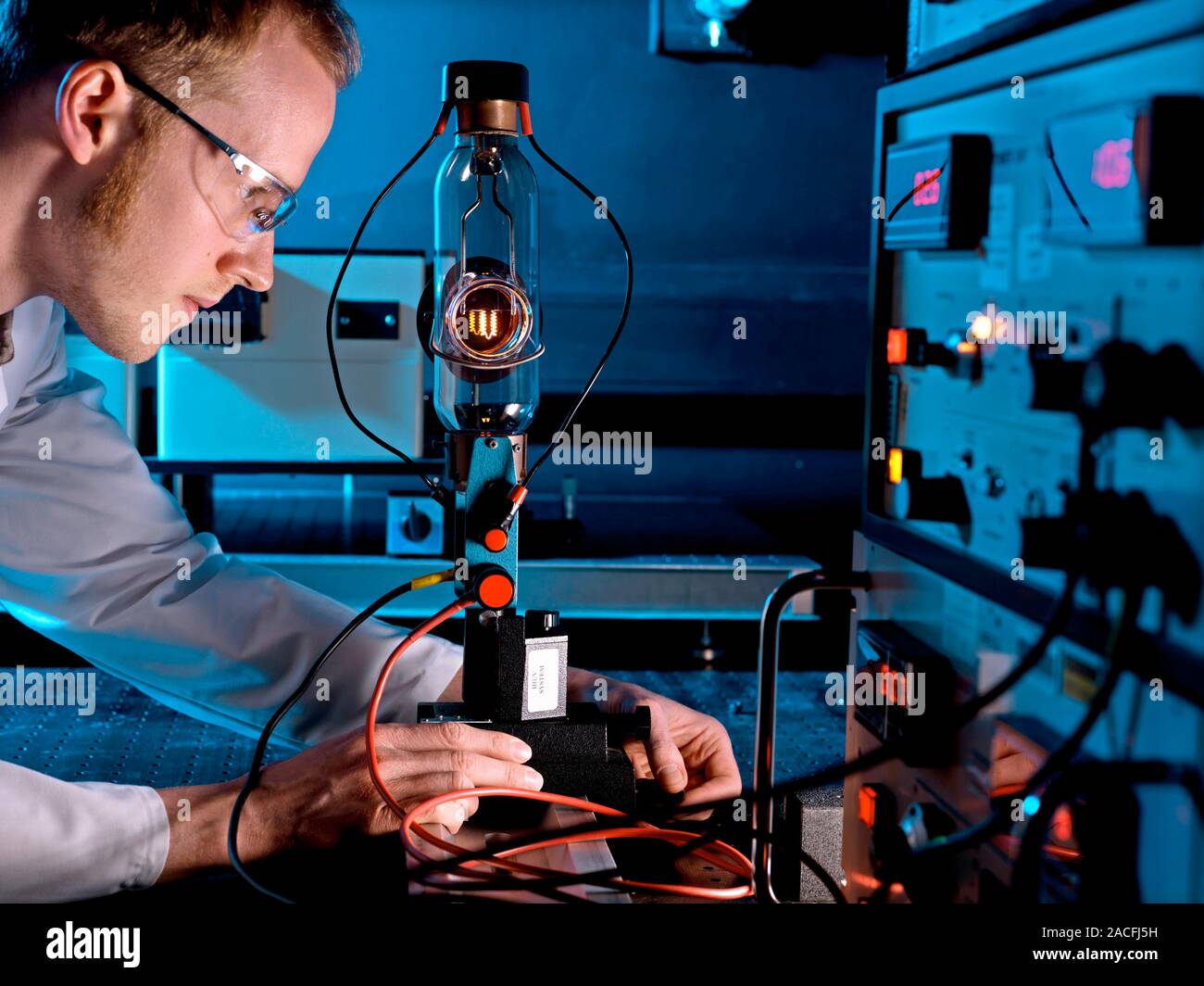 Phototherapy research. Technician using a dosimeter to measure the ...