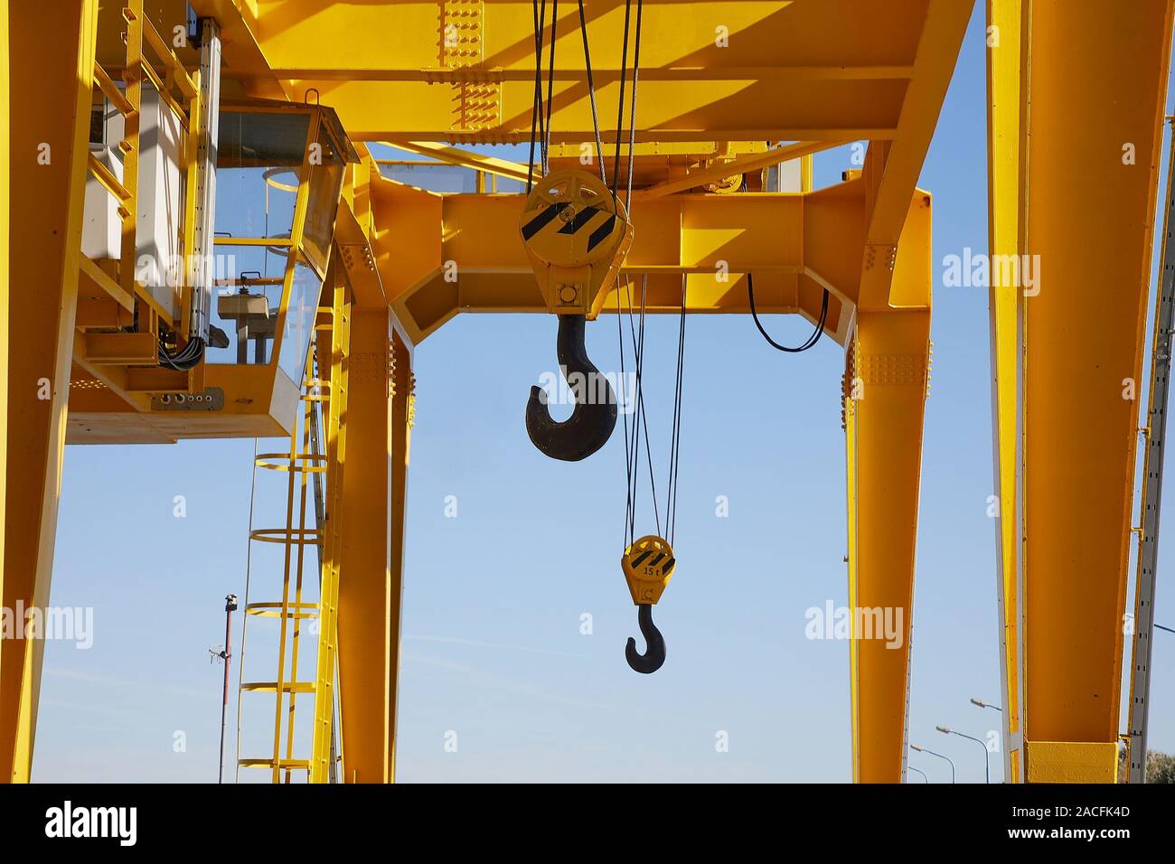 Crane with hooks hanging Stock Photo - Alamy