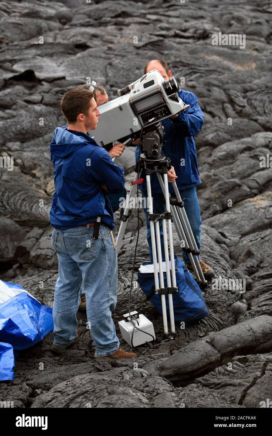 Documentary film crew. Camera team filming on a hardened lava field in ...