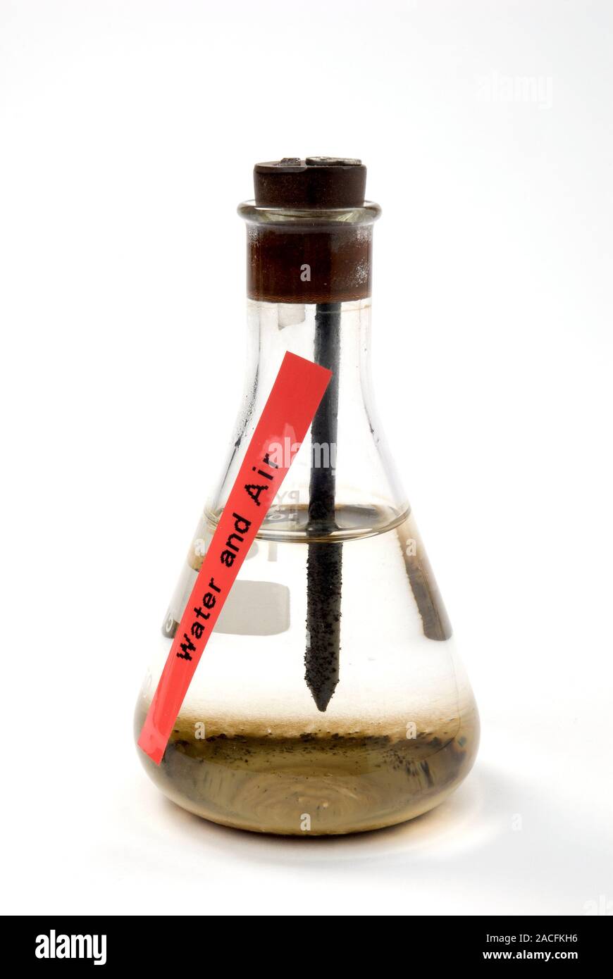 Iron nail in water and air. Experiment to show the corrosive effects of ...