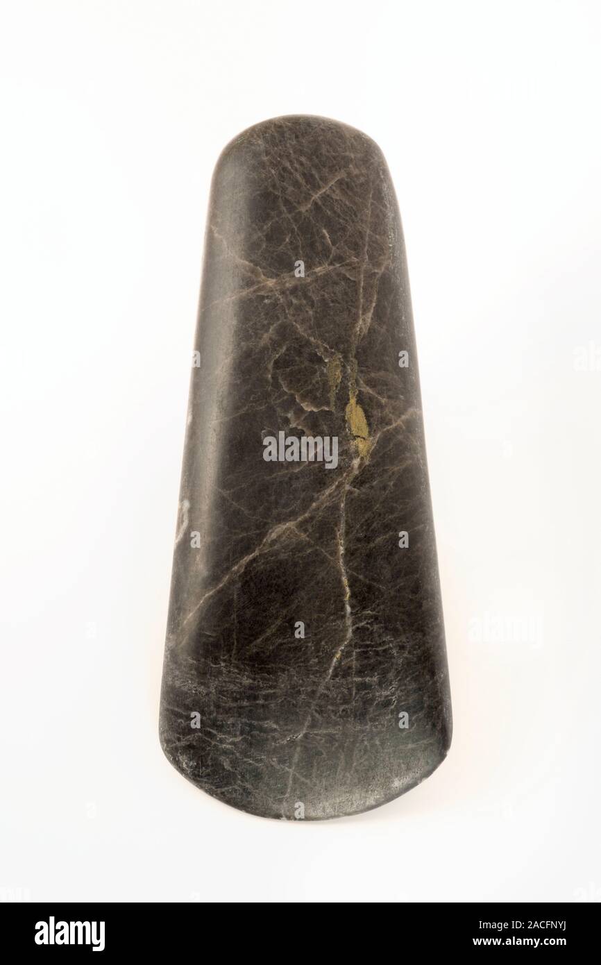 Stone axe head. Front view of a modern polished stone axe head, or celt ...