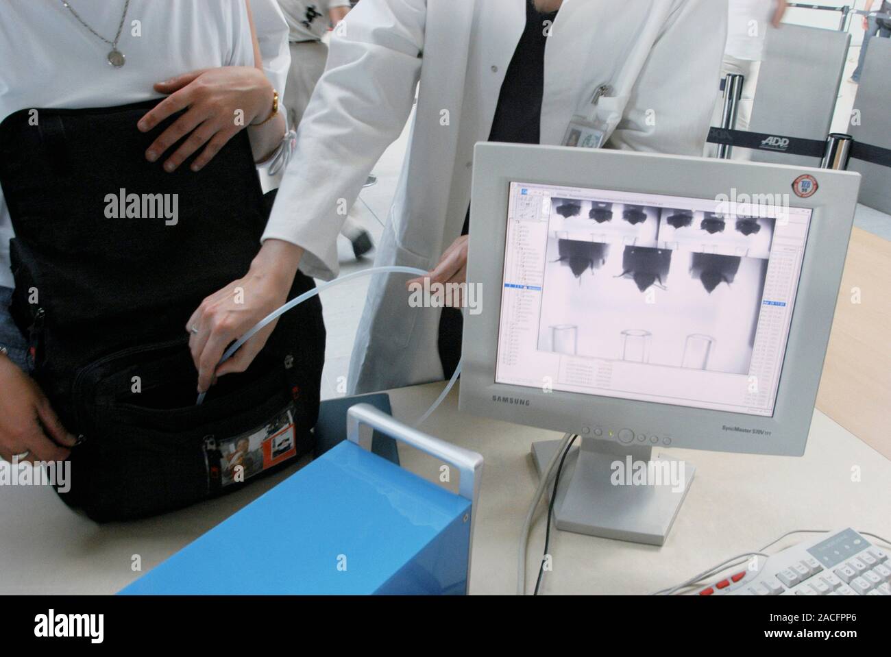Explosives detection using bees. Security guard at an airport using ...