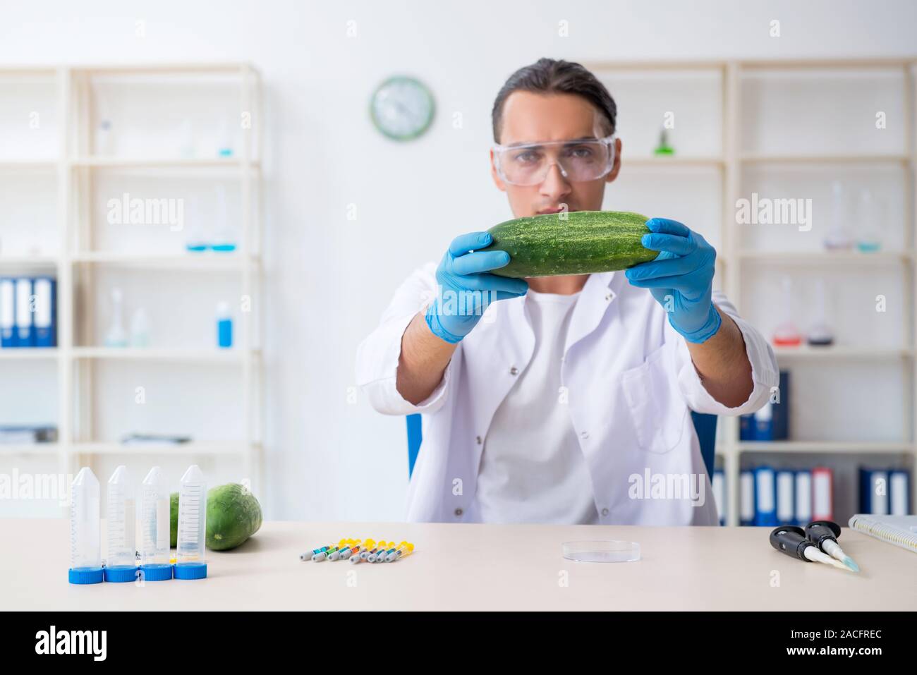 The male nutrition expert testing vegetables in lab Stock Photo - Alamy