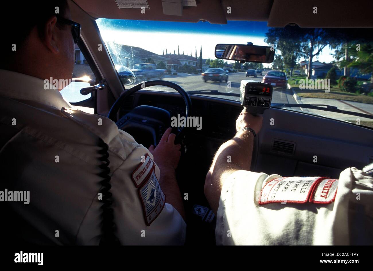 Private security speed check. Security guards using a laser speed gun ...