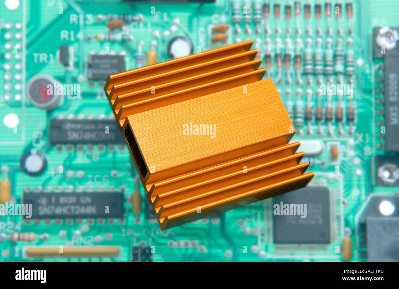 Microchip processor heat sink (centre), seen against a circuit board ...