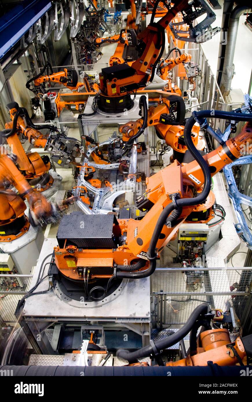 Car factory production line. Robots are used for heavy or dangerous ...