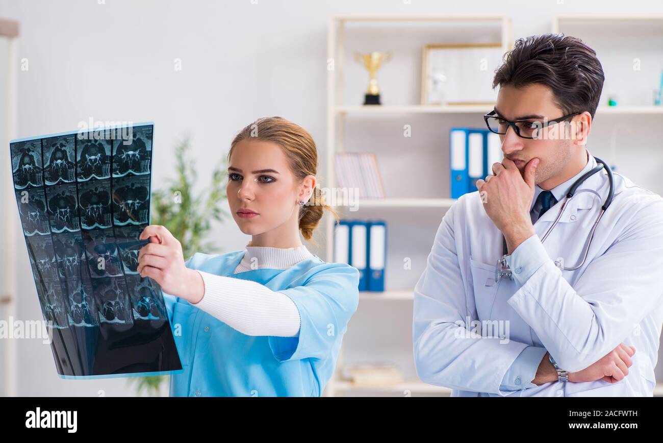 The two doctors examining x-ray images of patient for diagnosis Stock ...