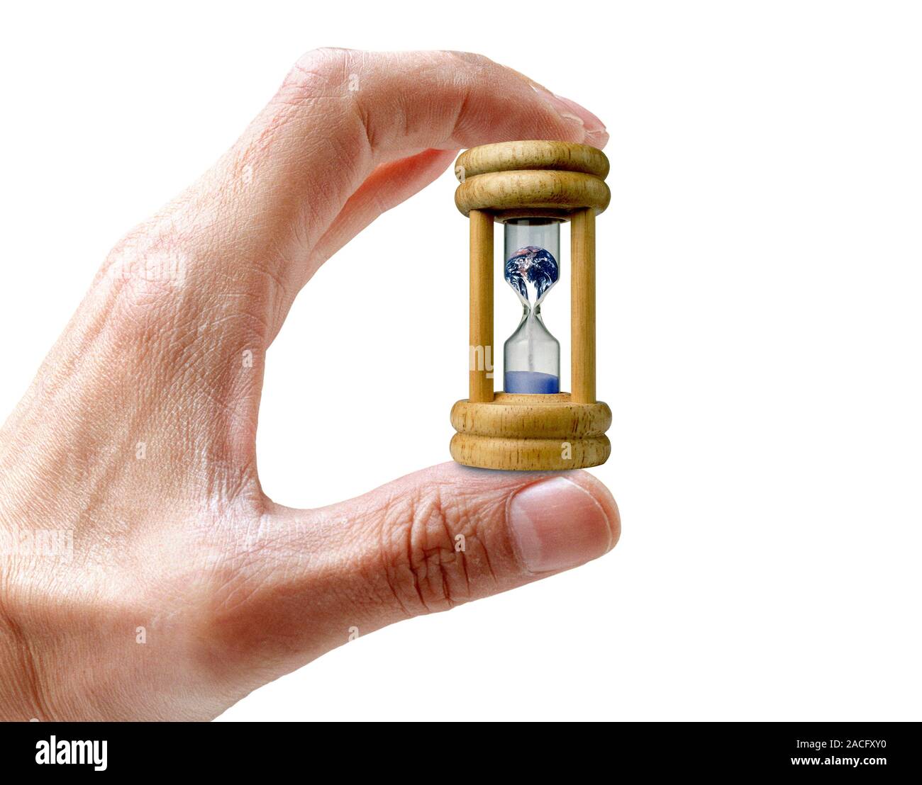 Geological time, conceptual artwork. Hand holding a sand timer with an ...