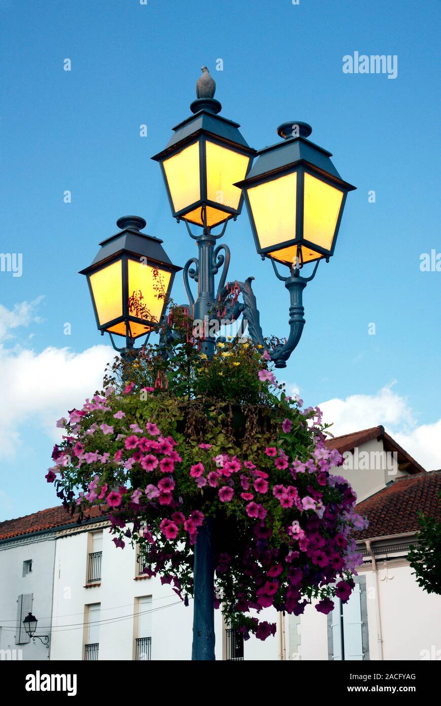 Lampost with hanging baskets in a French market town. Photographed in ...