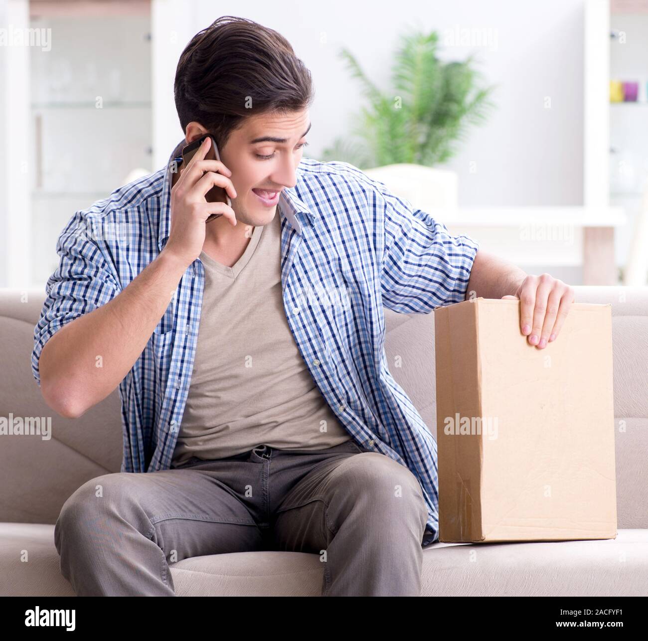The man receiving parcel at home Stock Photo - Alamy