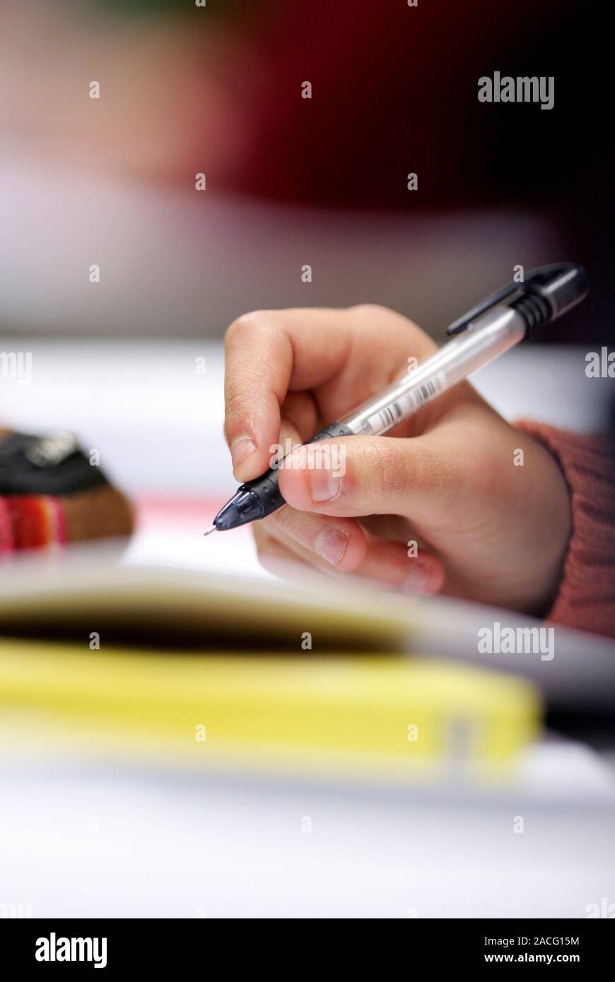 Teenager writing. Hand of a teenager writing in an exercise book during ...