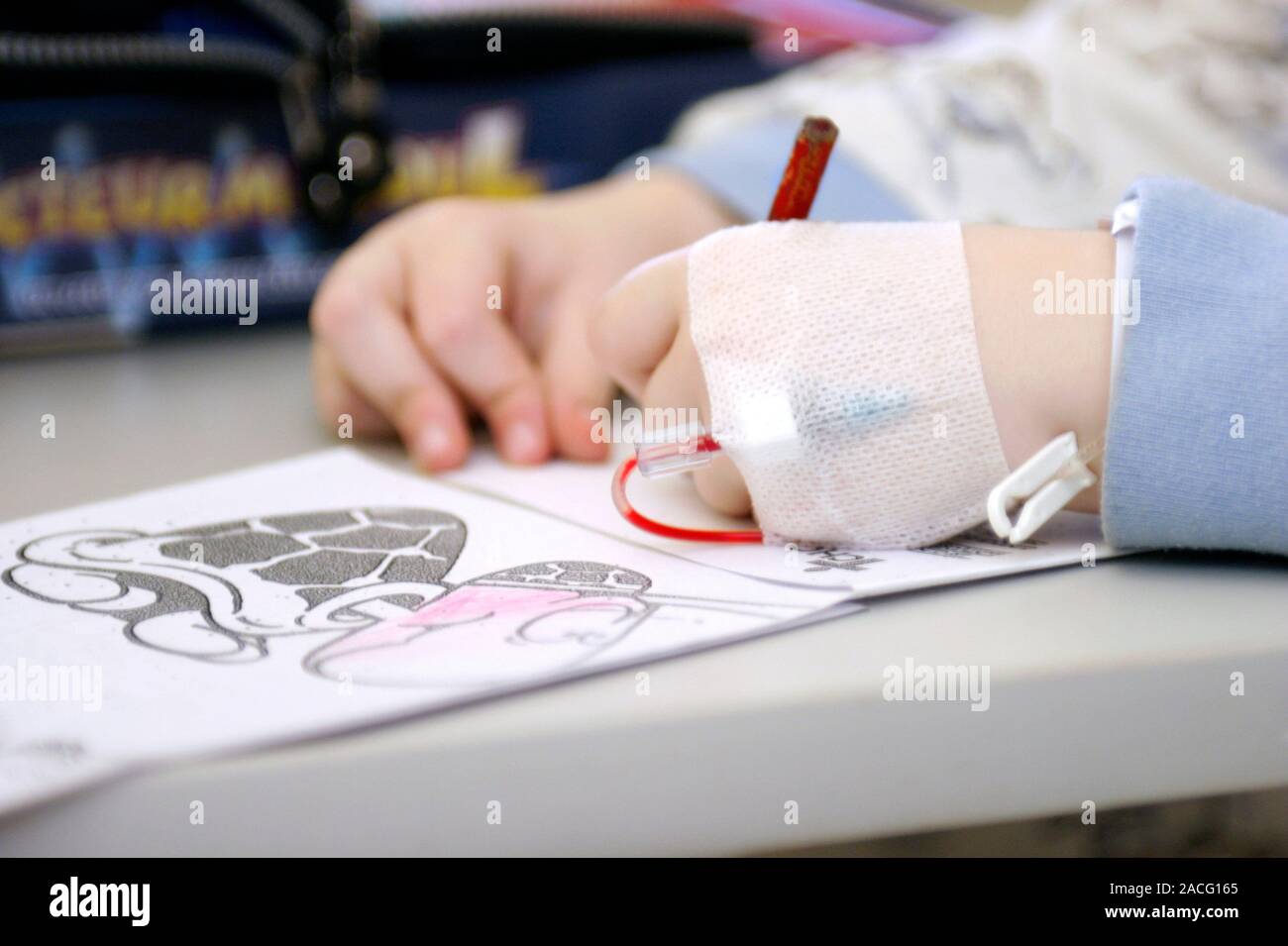Child patient colouring in a drawing while in a hospital. Photographed ...