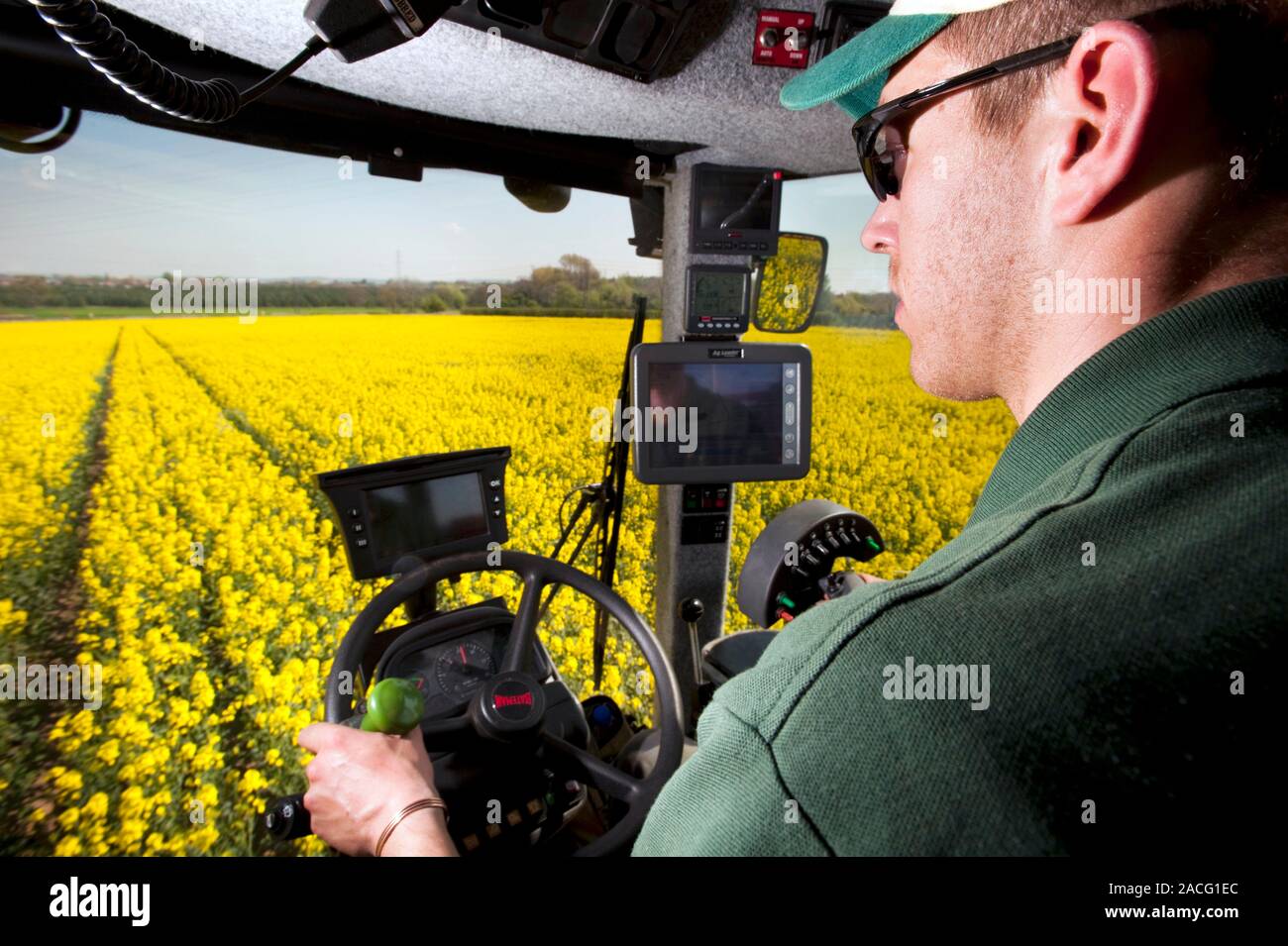Crop spraying. Crop sprayer operator's view of applying pesticides to ...