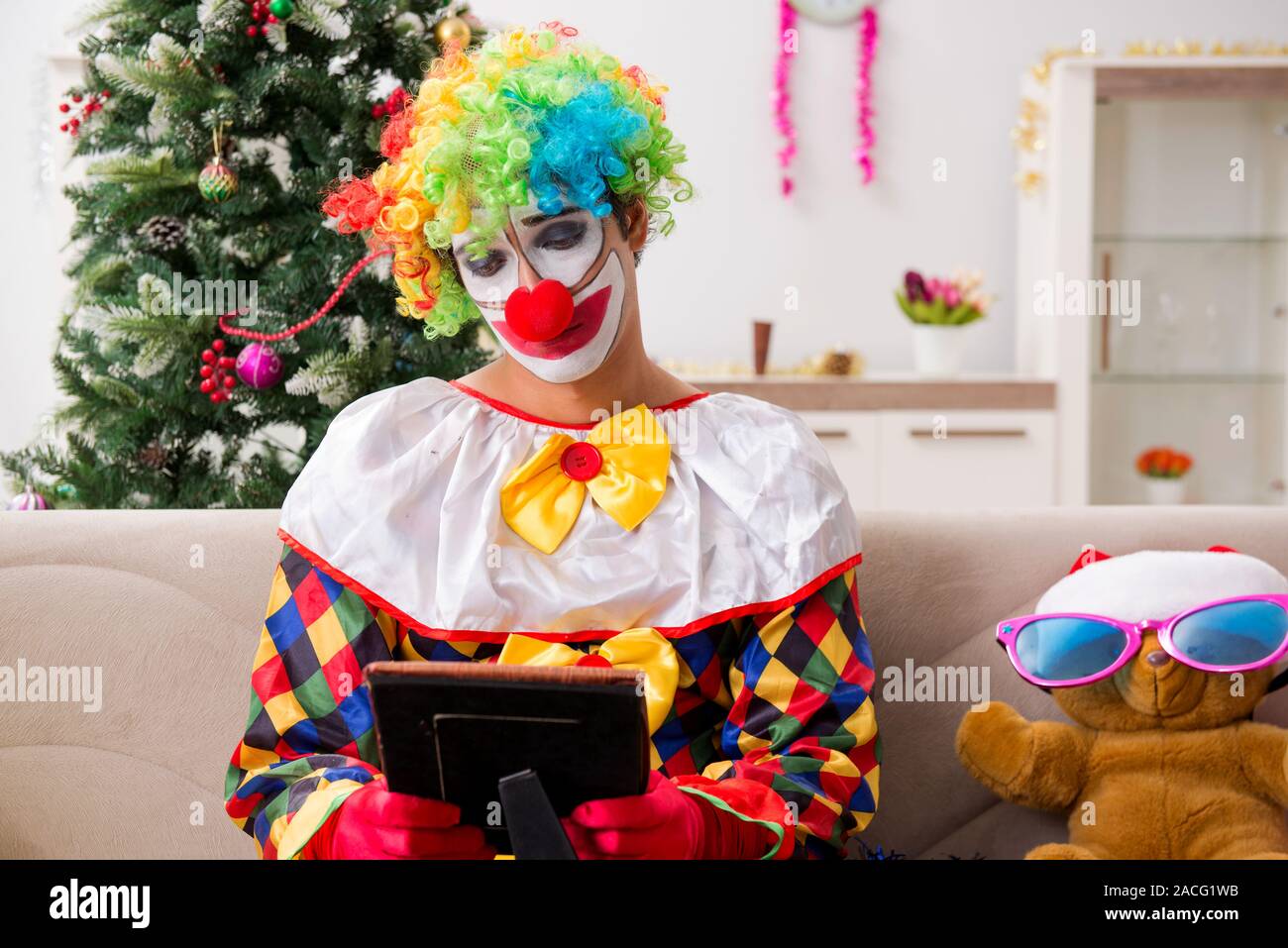 The funny clown in christmas celebration concept Stock Photo - Alamy