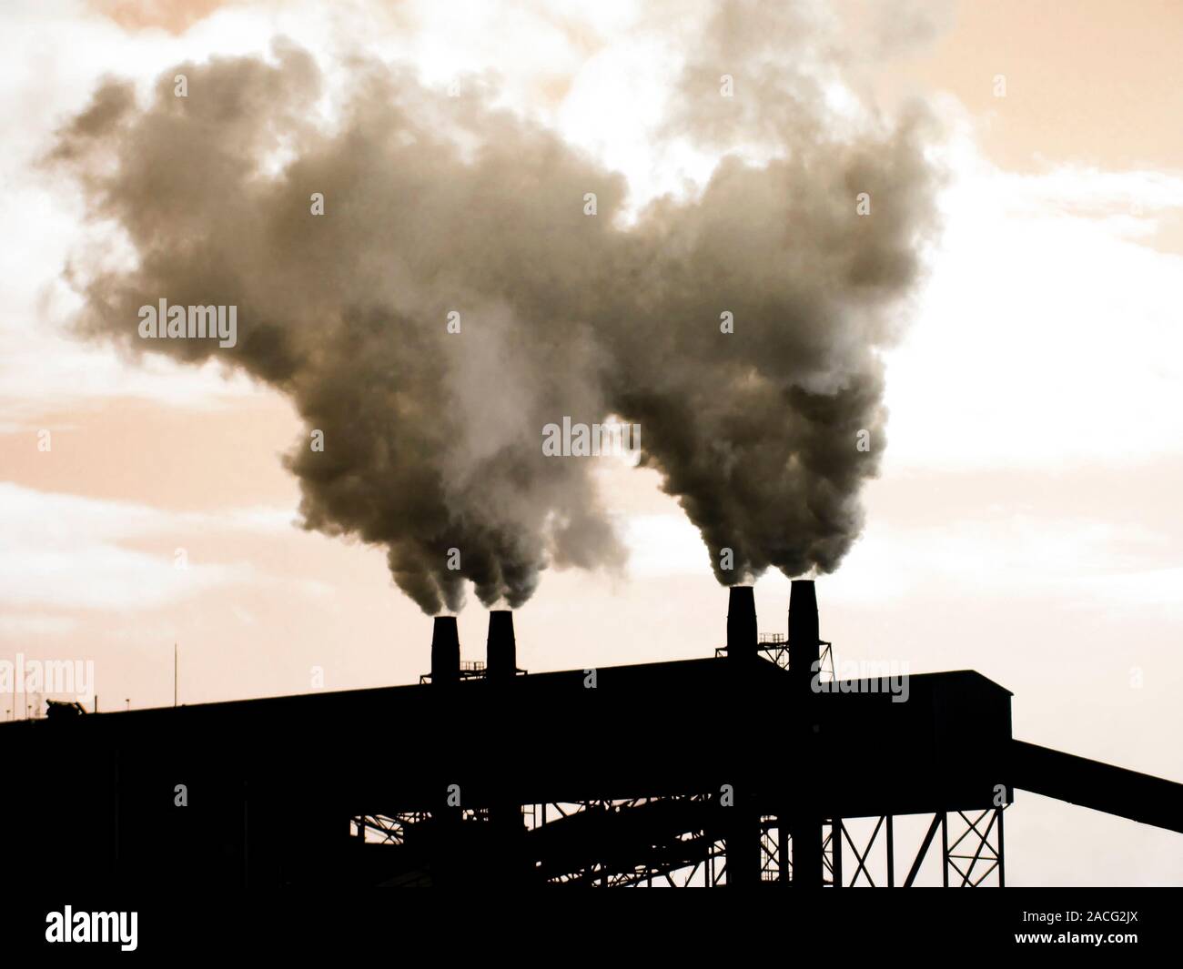 Industrial air pollution. Smoke billowing from a steel mill's chimney ...
