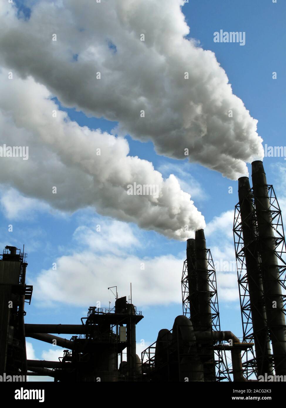 Industrial air pollution. Smoke billowing from a steel mill's chimney ...