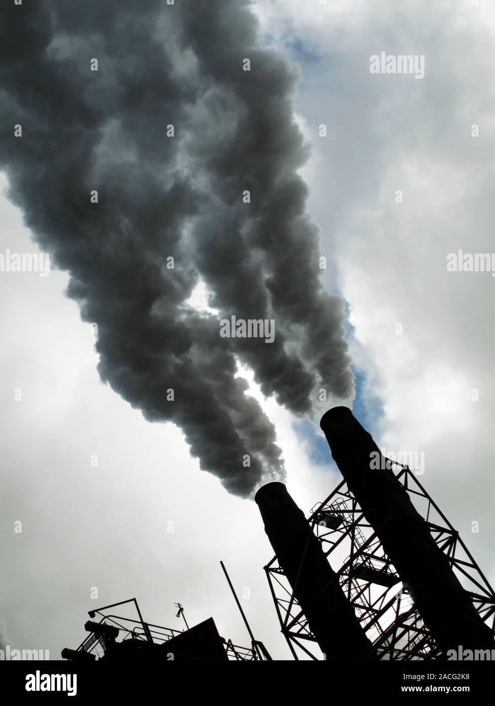 Industrial air pollution. Smoke billowing from a steel mill's chimney ...