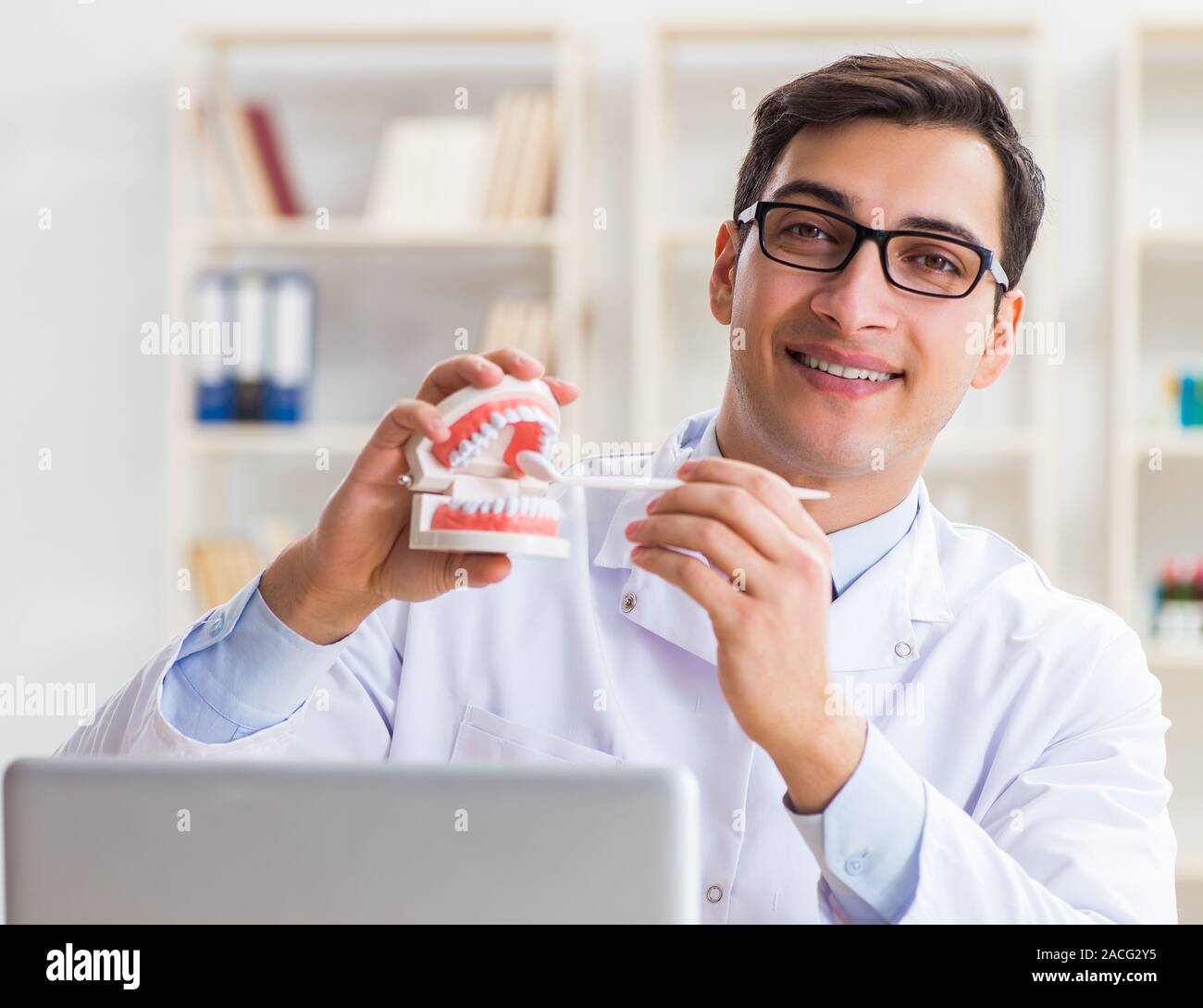 The young dentist working in the dentistry hospital Stock Photo - Alamy